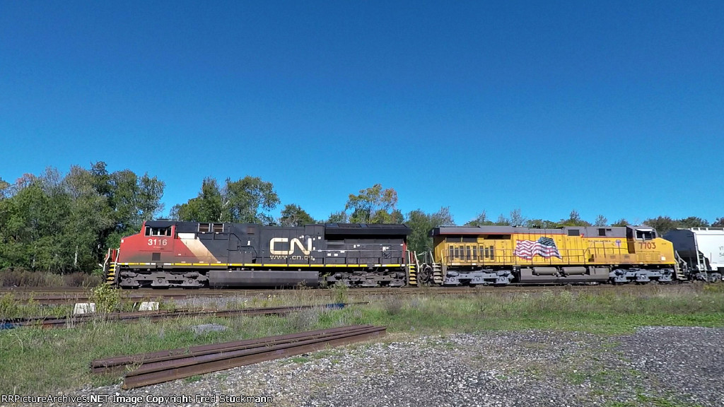 CN 3116 & UP 7703 head west with a manifest.